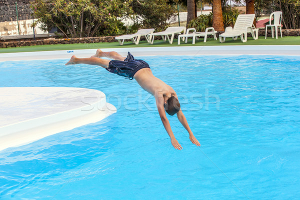 man jumping into pool
